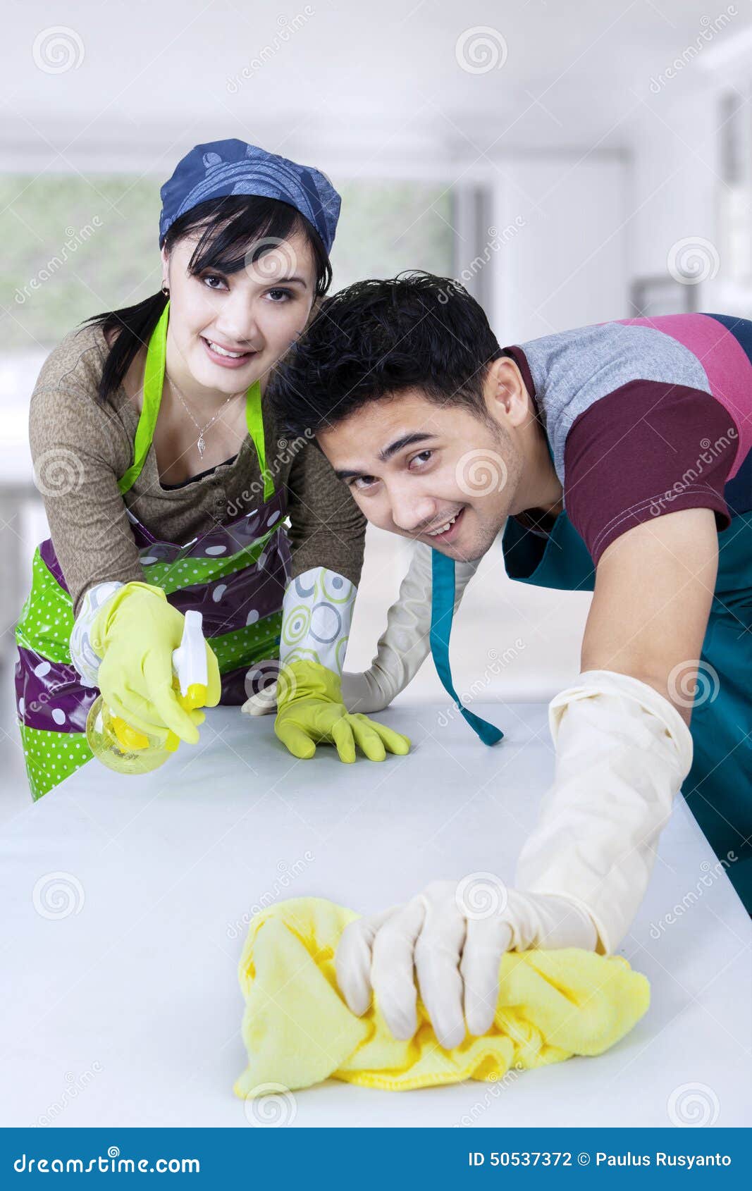 Young Couple Cleaning a Table Stock Photo - Image of gloves, apron ...