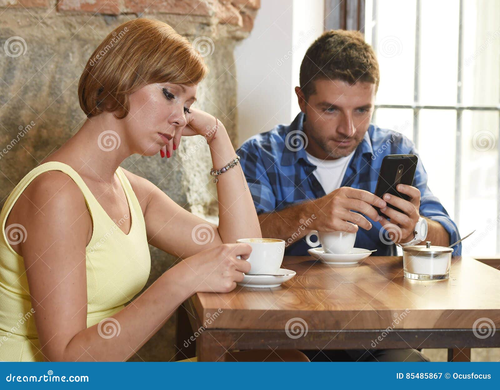 Young Couple at Coffee Shop with Internet and Mobile Phone Addict Man ... Young Couple at Coffee Shop with Internet and Mobile Phone Addict Man ...