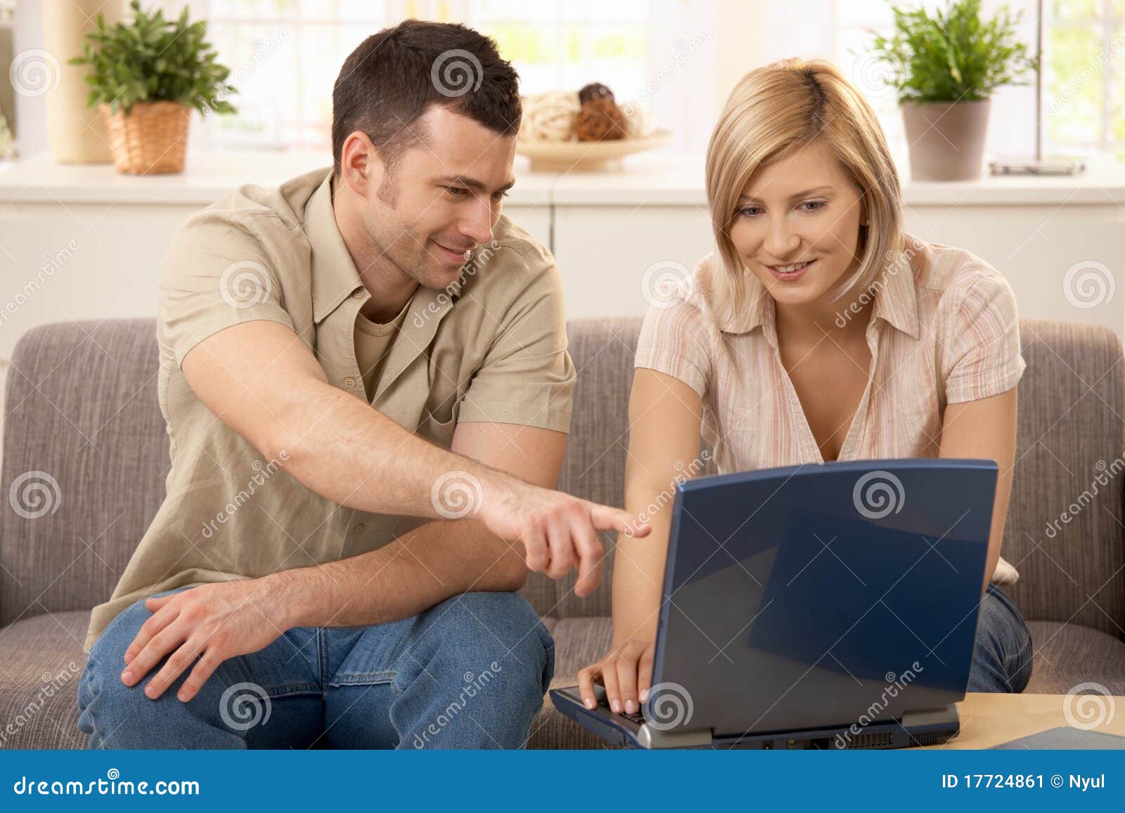 Young couple with computer stock image. Image of clothing - 17724861