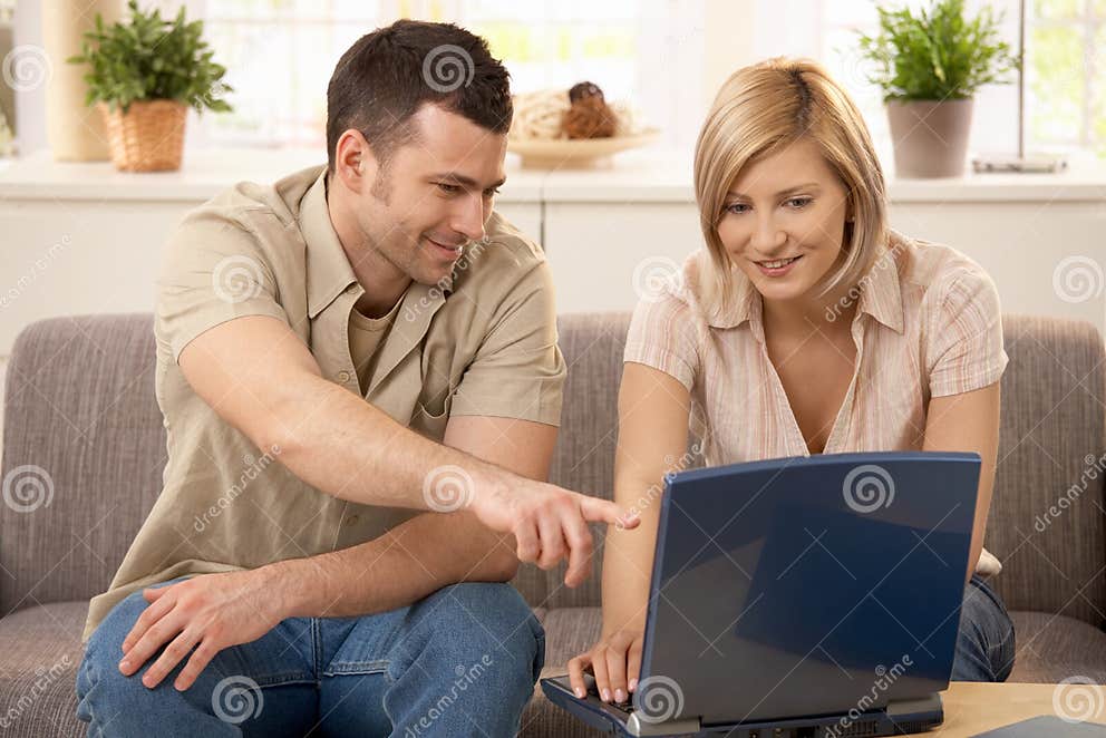 Young couple with computer stock image. Image of clothing - 17724861