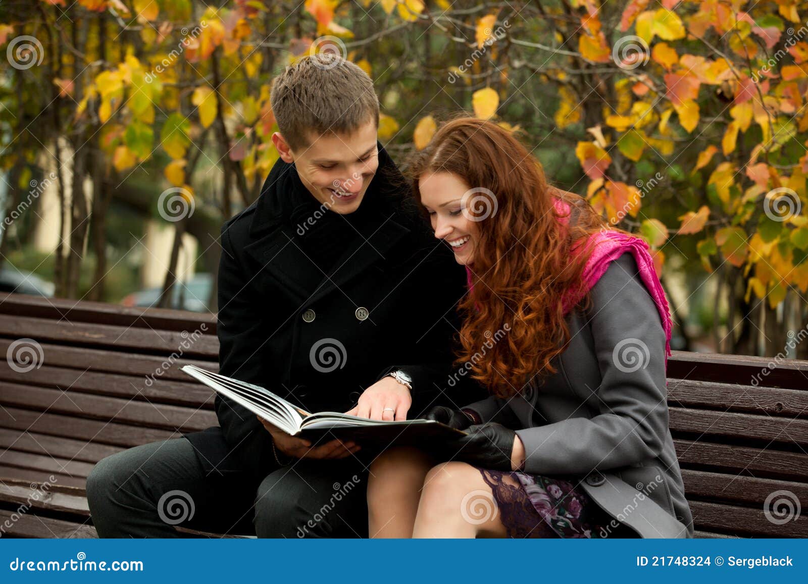 Young Couple is Considering a Book Stock Photo - Image of people ...