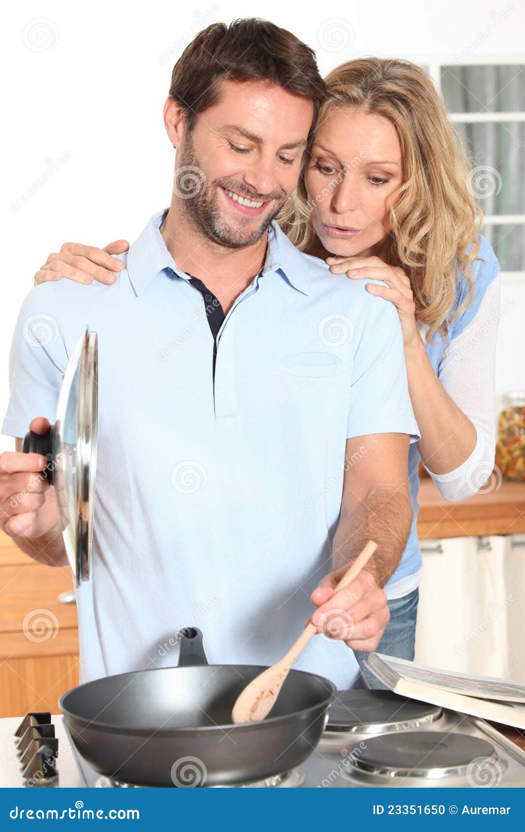 Young Couple Cooking in Kitchen Stock Photo - Image of shoulders, adult ...