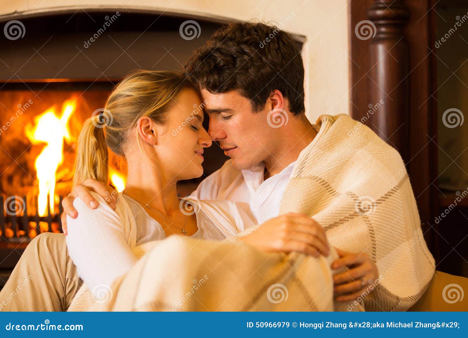 Young couple cuddling stock image. Image of fireplace - 50966979