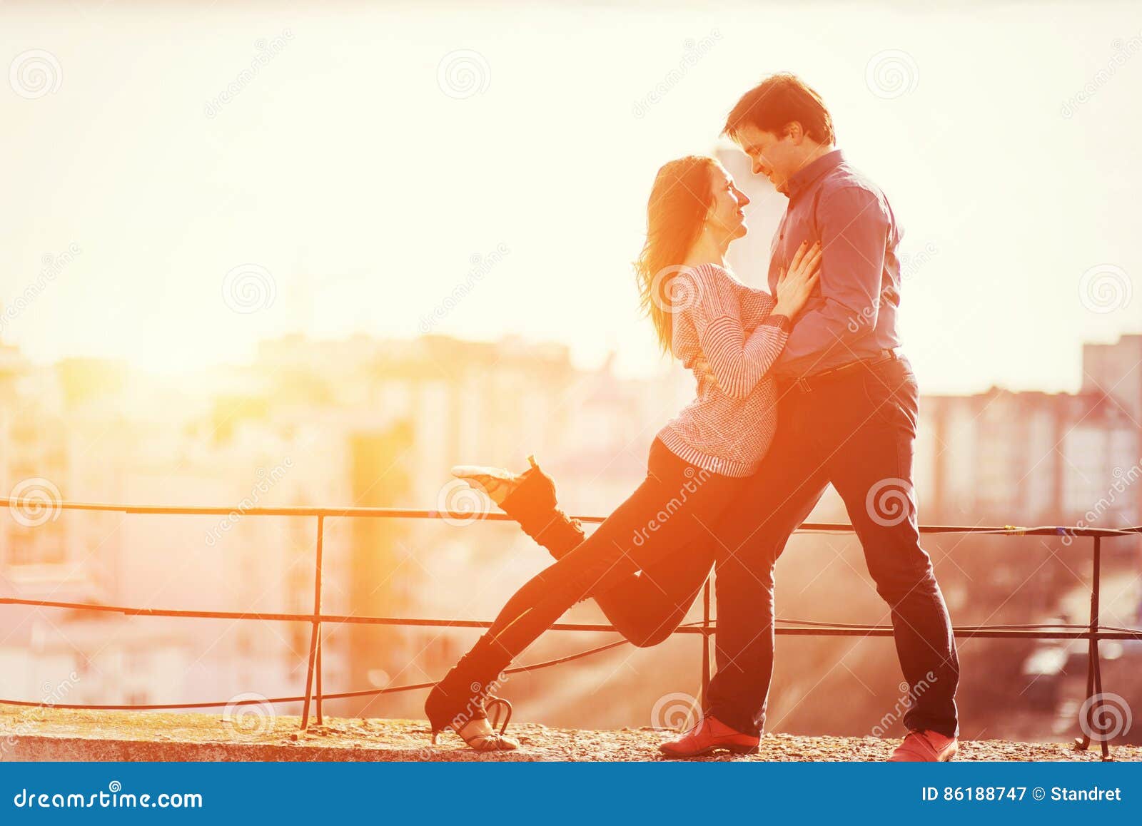 Young Couple Dancing on the Roof of a Tall Building Stock Image - Image ...