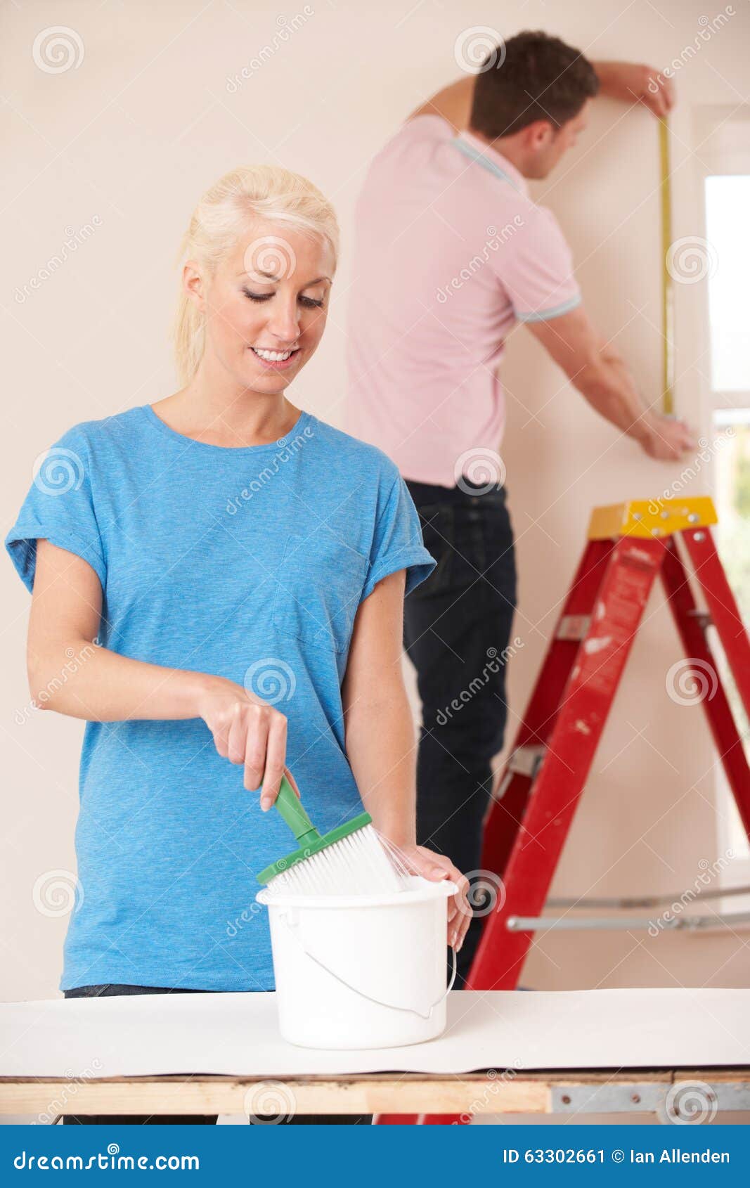 Young Couple Decorating Home Together Stock Image - Image of people ...