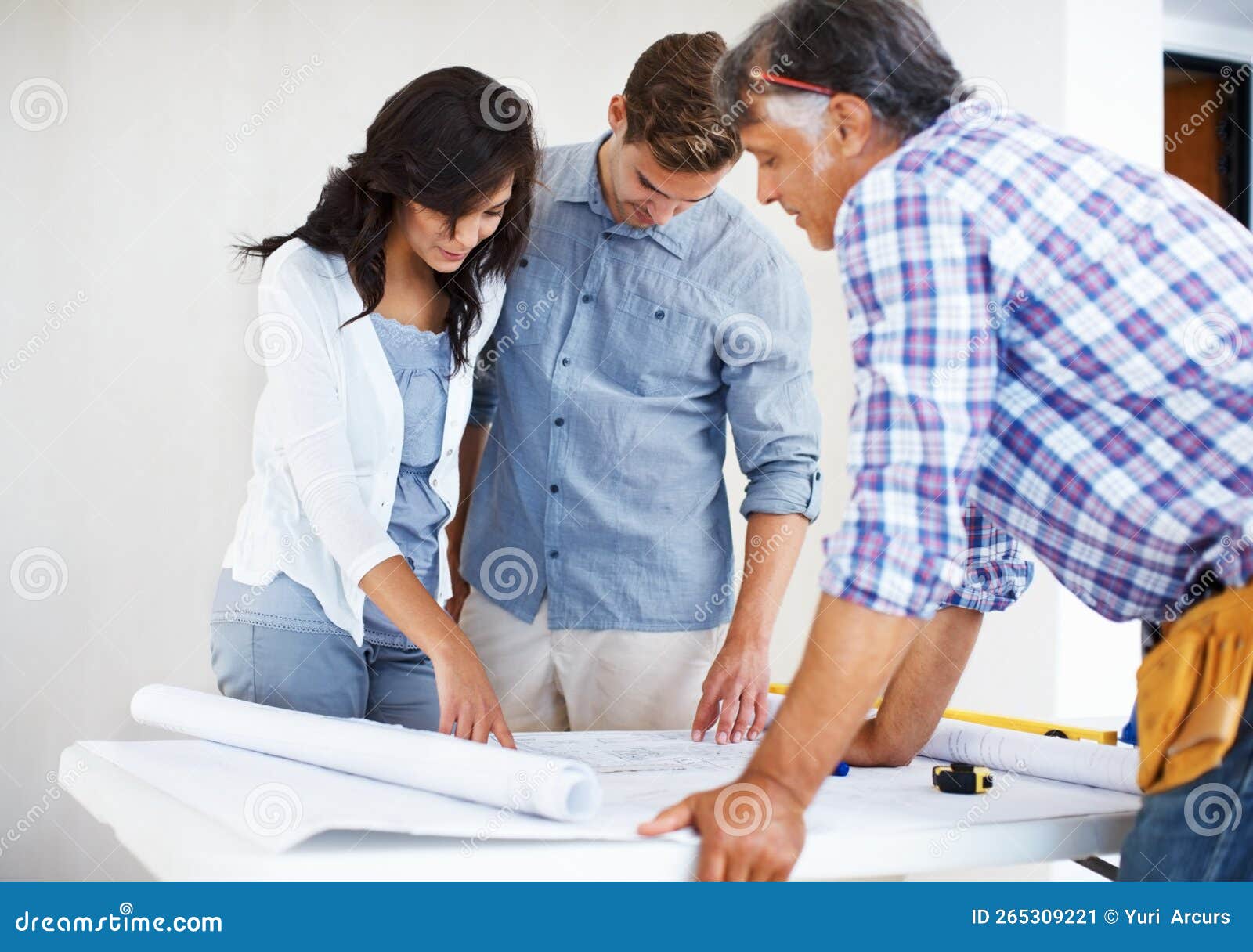 Young Couple Discussing House Plan with Architect. Young Couple ...