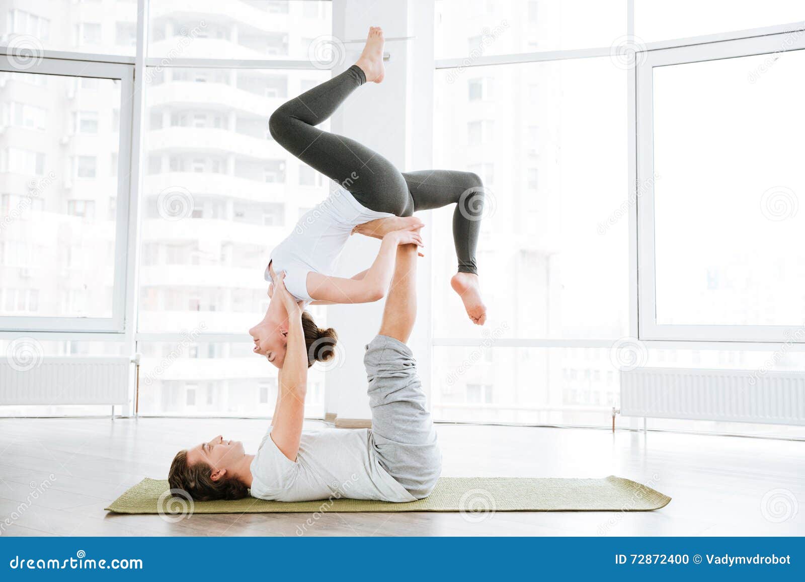 Young Couple Doing Acro Yoga Exercises Stock Photo - Image of ...