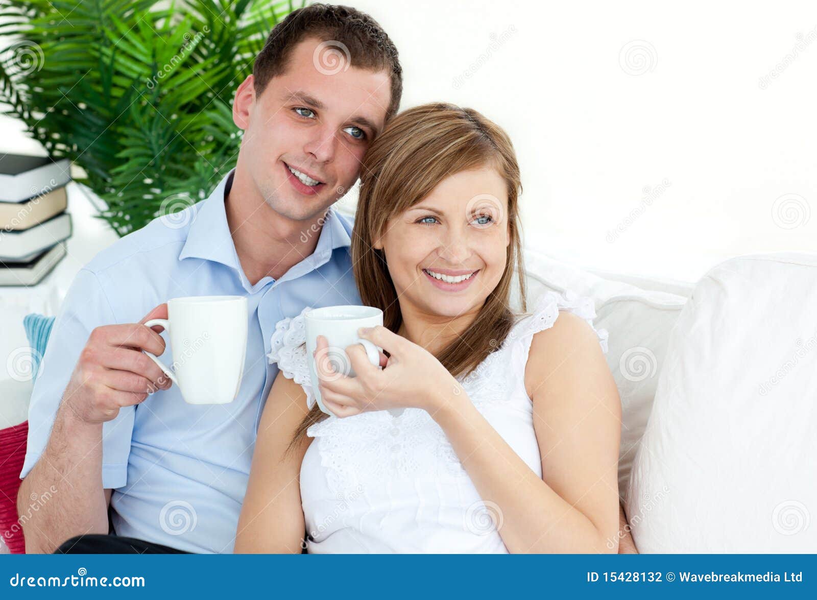 Young Couple Drinking Coffee Together on the Sofa Stock Photo - Image ...