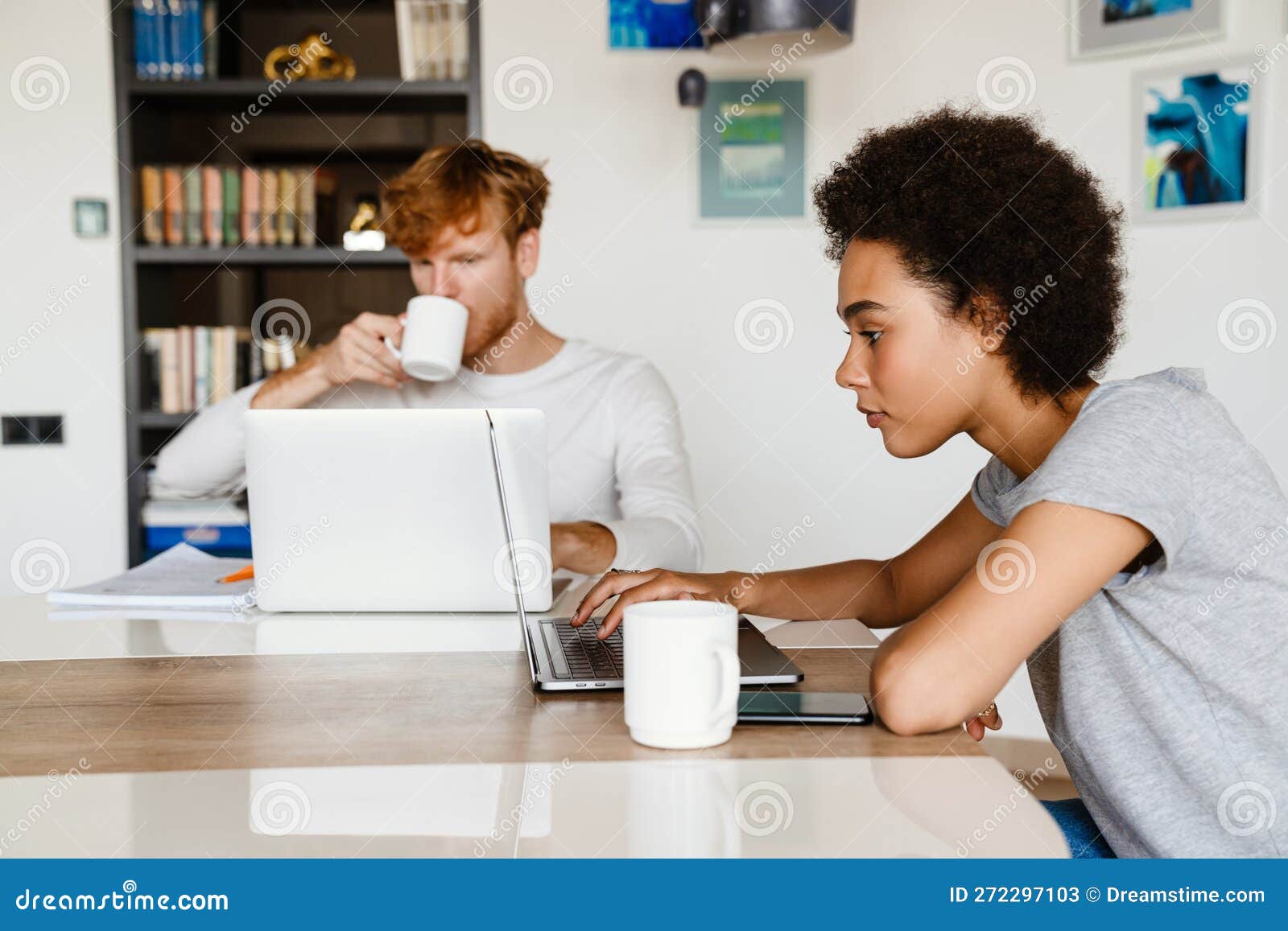 Young Couple Drinking Coffee while Using Laptops Together at Home Stock ...