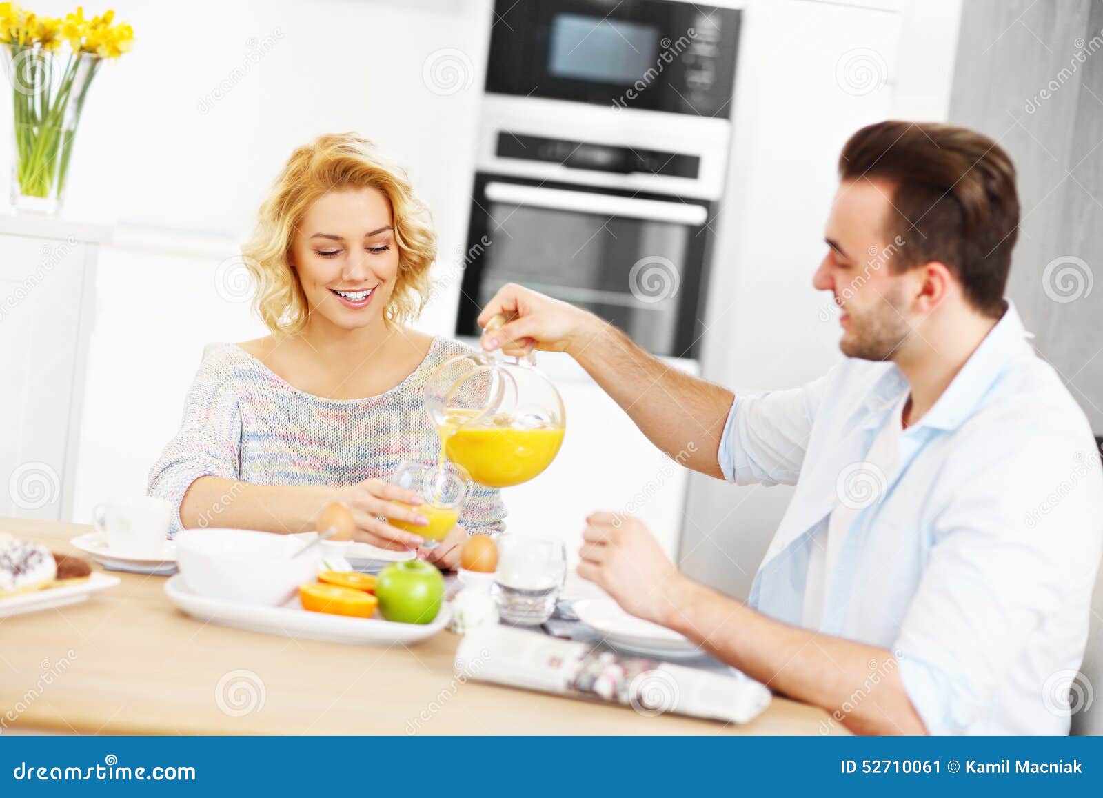 Young Couple Eating Breakfast Stock Image - Image of female, holding ...
