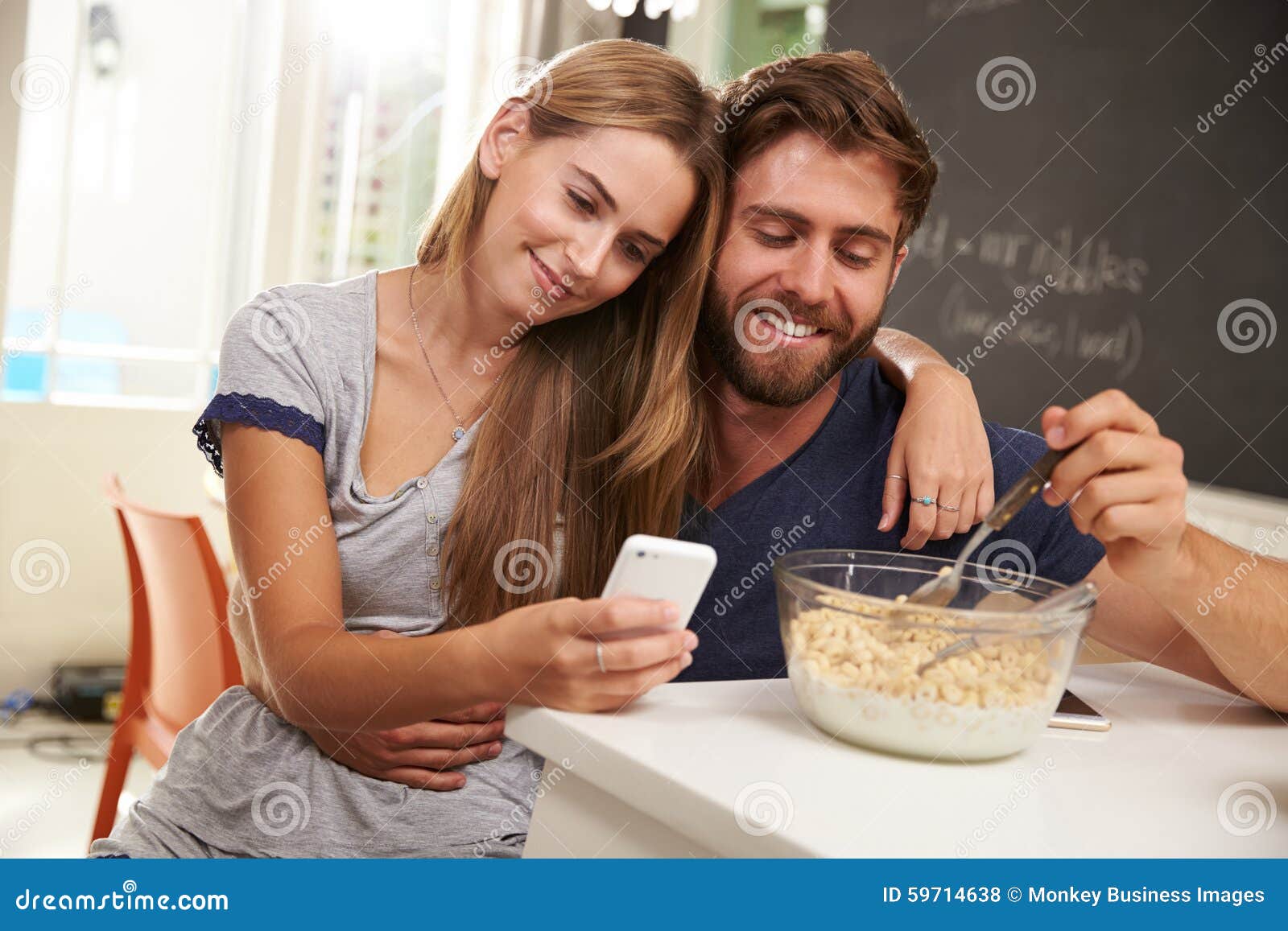 Young Couple Eating Breakfast Whilst Using Mobile Phones Stock Photo ...