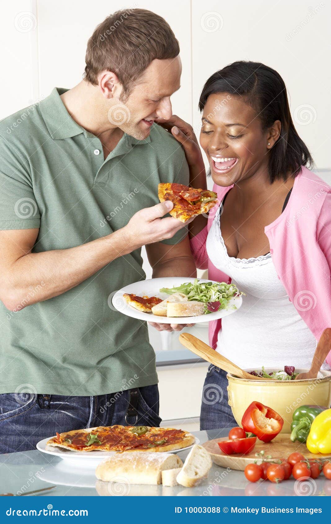 Young Couple Eating Meal in Kitchen Stock Photo - Image of serving ...