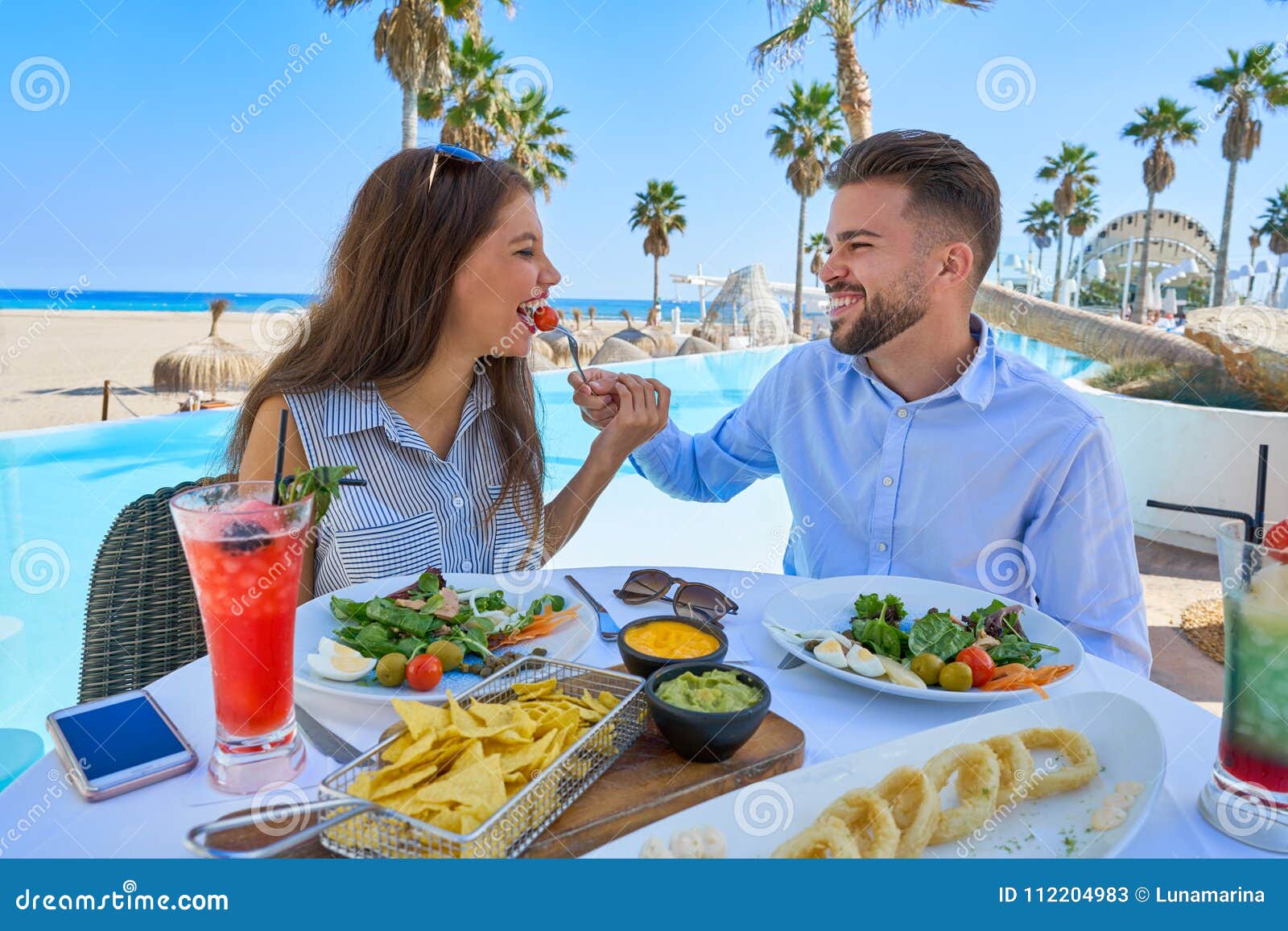 Young Couple Eating in a Pool Restaurant Stock Image - Image of lovers ...