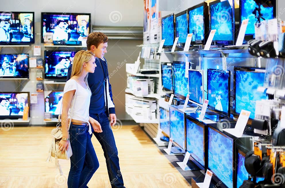 Young Couple in Electronics Store Looking at TVs Stock Photo - Image of ...