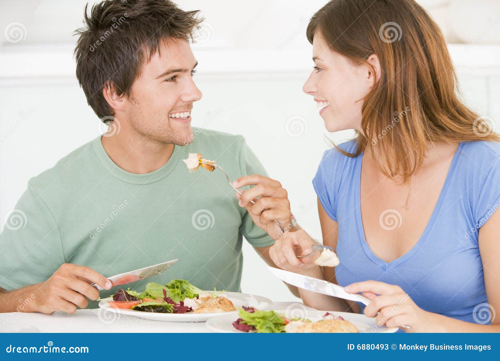 Young Couple Enjoying Meal stock image. Image of inside - 6880493