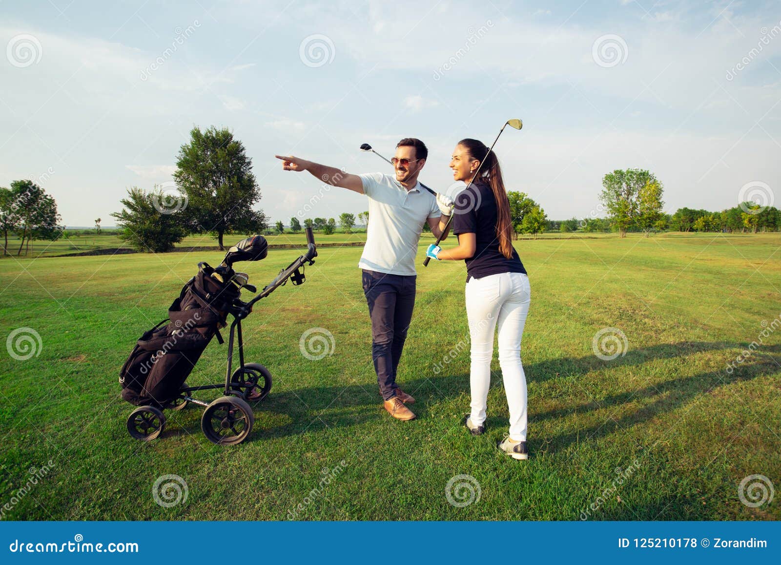 Young Couple Enjoying Time on a Golf Course Stock Photo - Image of ...