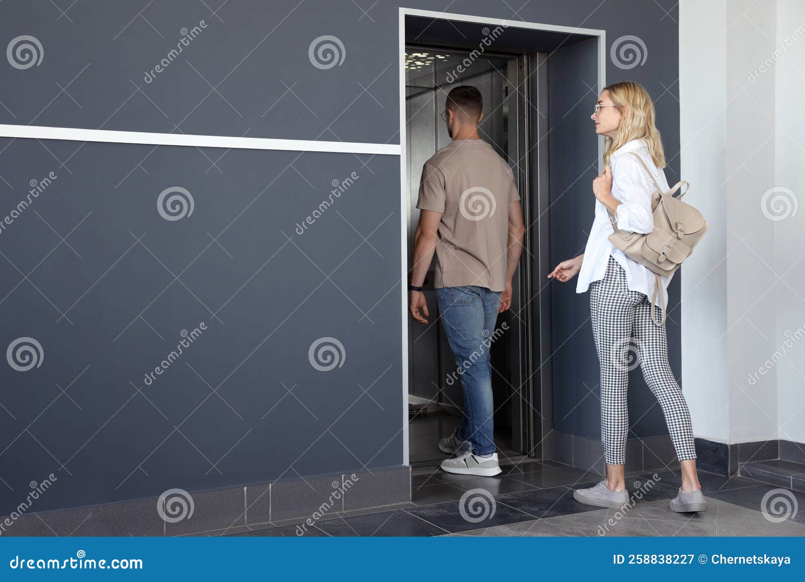 Young Couple Entering Modern Elevator, Back View Stock Image - Image of ...