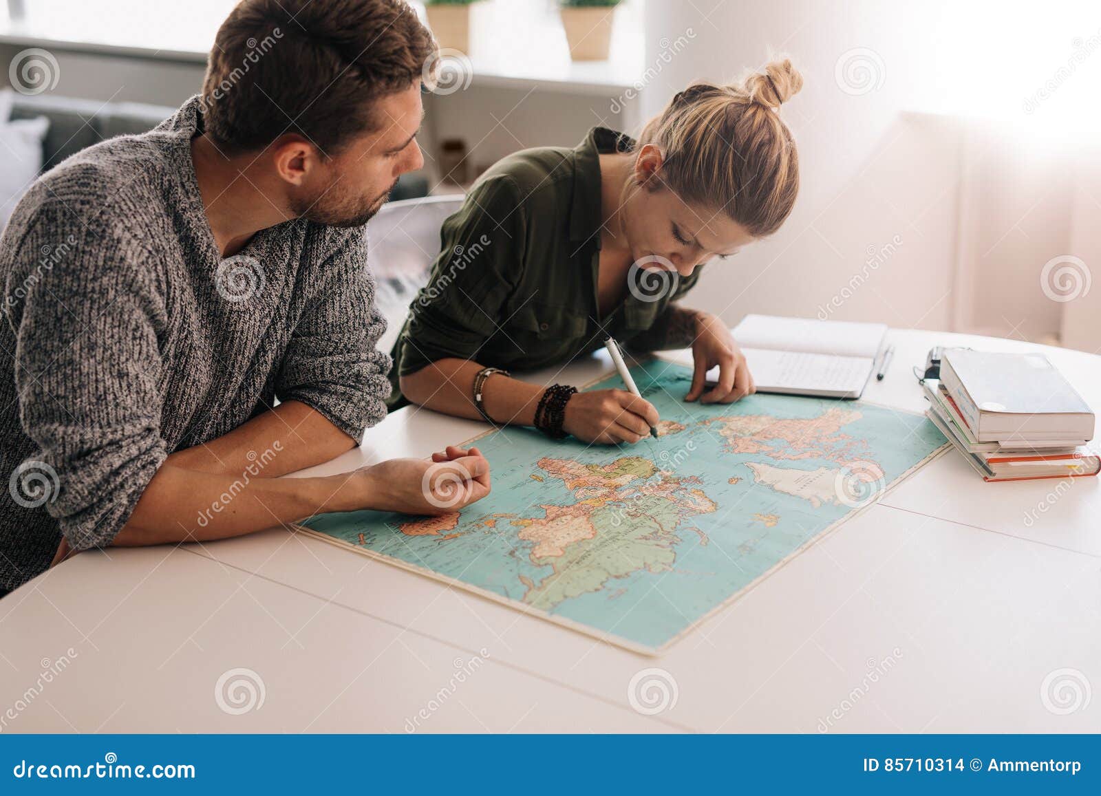 Young Couple Exploring the World Map. Stock Photo - Image of world ...