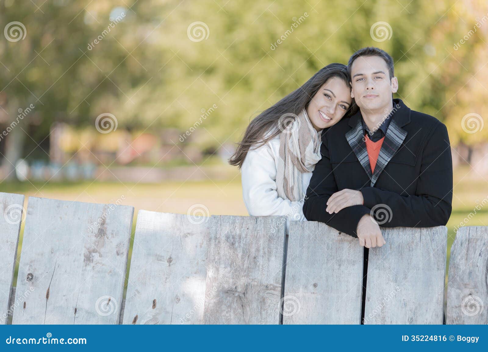Young couple by the fence stock photo. Image of bonding - 35224816