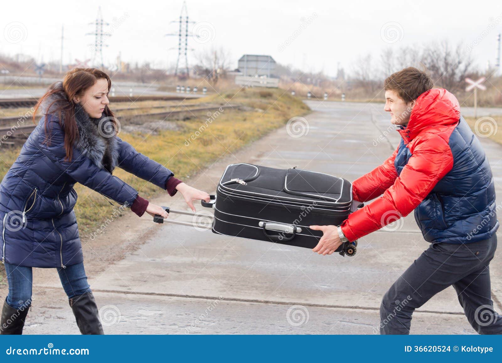 Young Couple Fighting Over a Suitcase Stock Photo - Image of railway ...