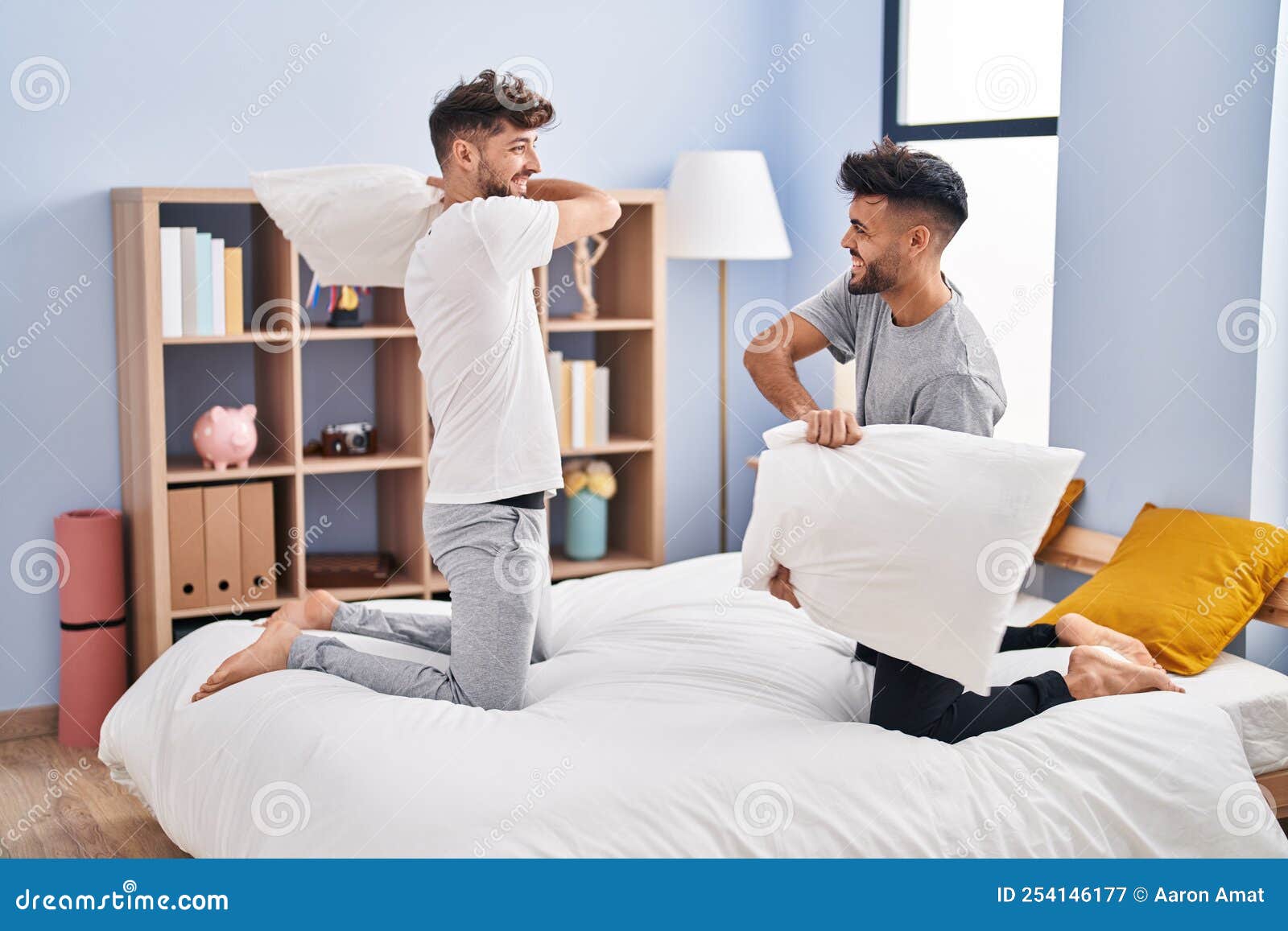 Young Couple Fighting with Pillow on Bed at Bedrooom Stock Image ...