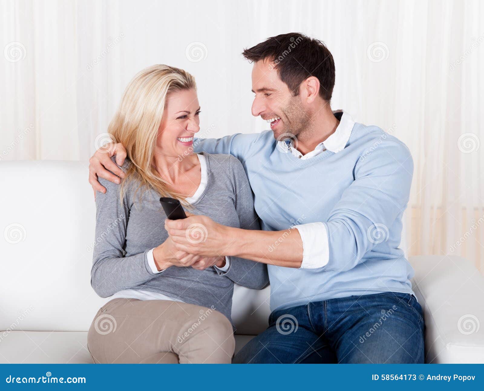 Young Couple Fighting for TV Remote Stock Image - Image of handsome ...
