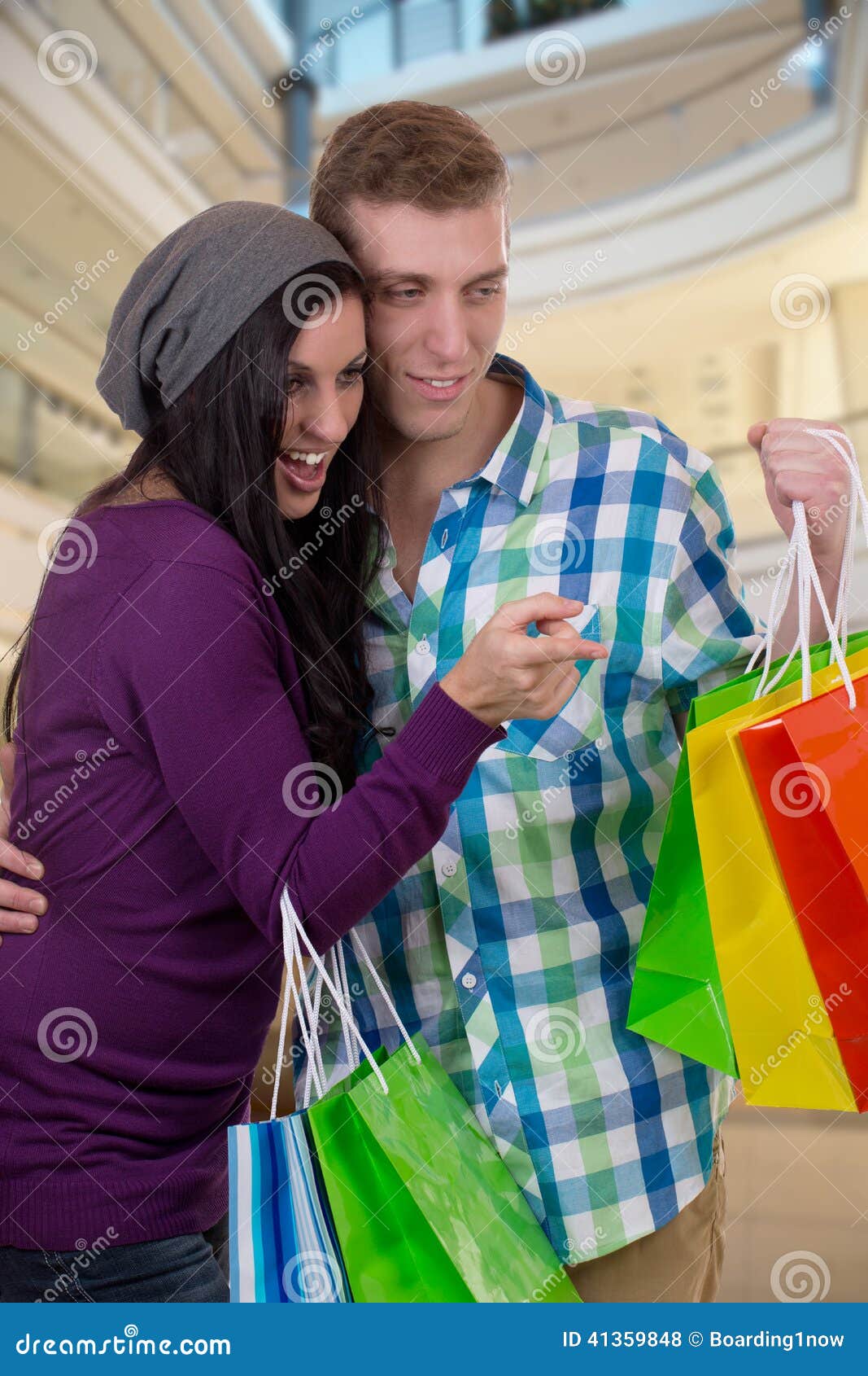 Young Couple is Finding Something while Shopping in a Mall Stock Photo ...