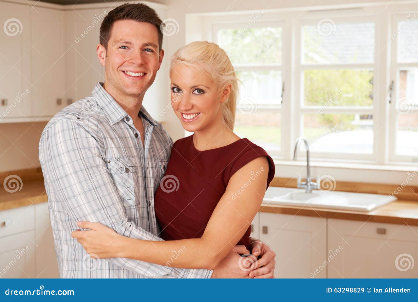 Young Couple in First Home Together Stock Image - Image of kitchen ...