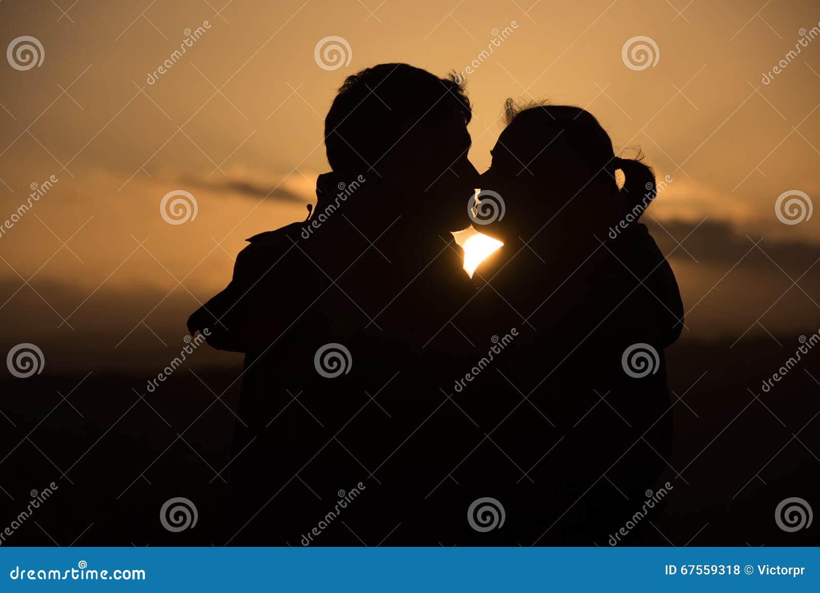 Young Couple in Front of Sunset Stock Photo - Image of autumn, cold ...