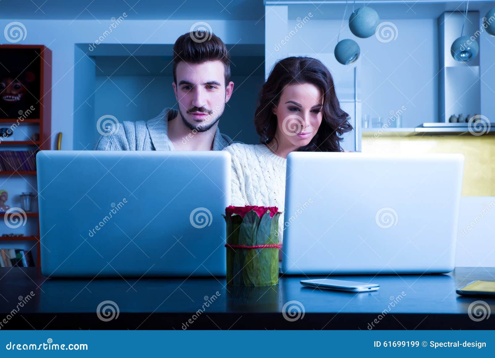 Young Couple in Front of Their Laptop Computers at Home Stock Image ...