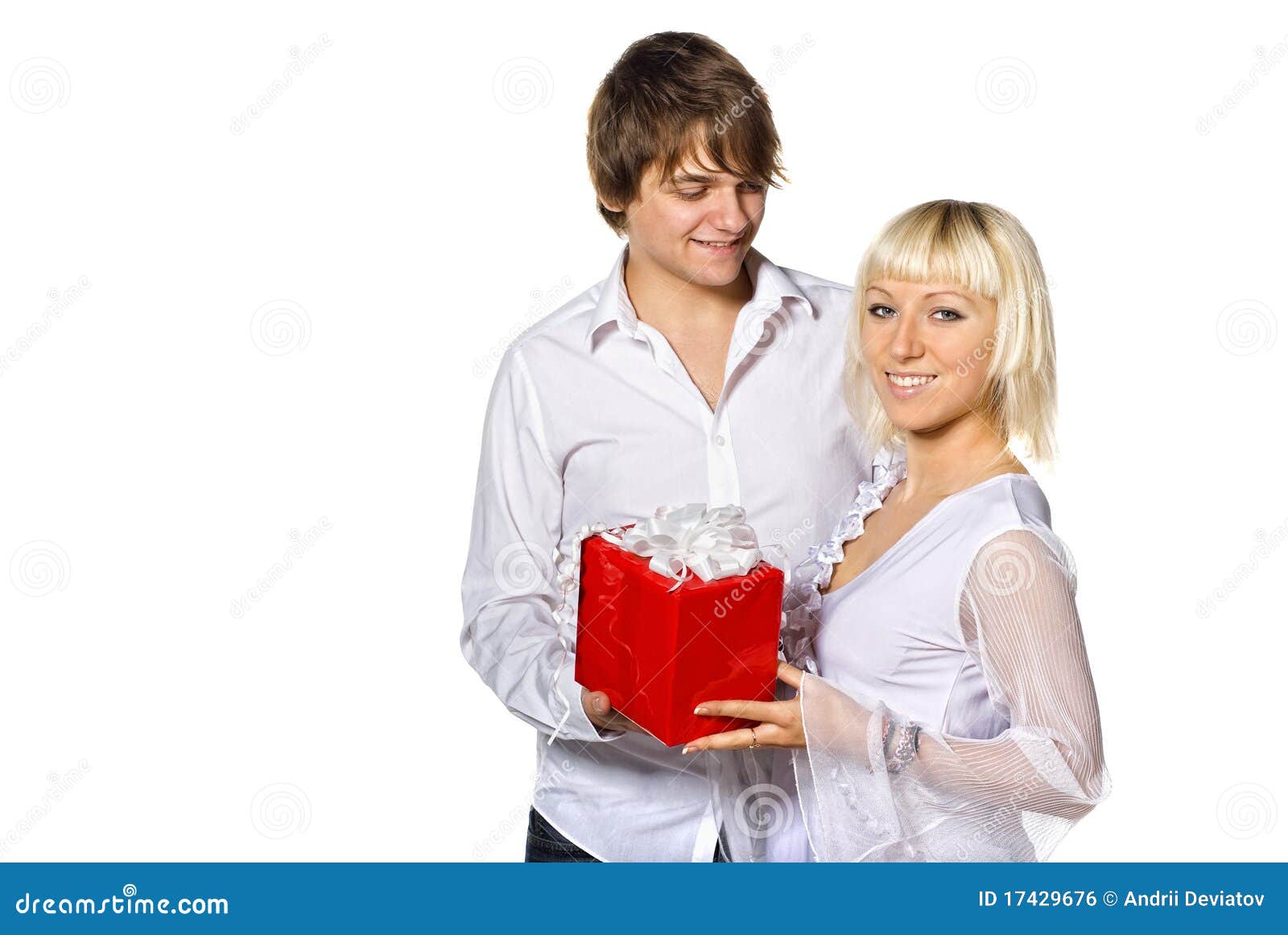 Young couple with gift box stock photo. Image of studio - 17429676