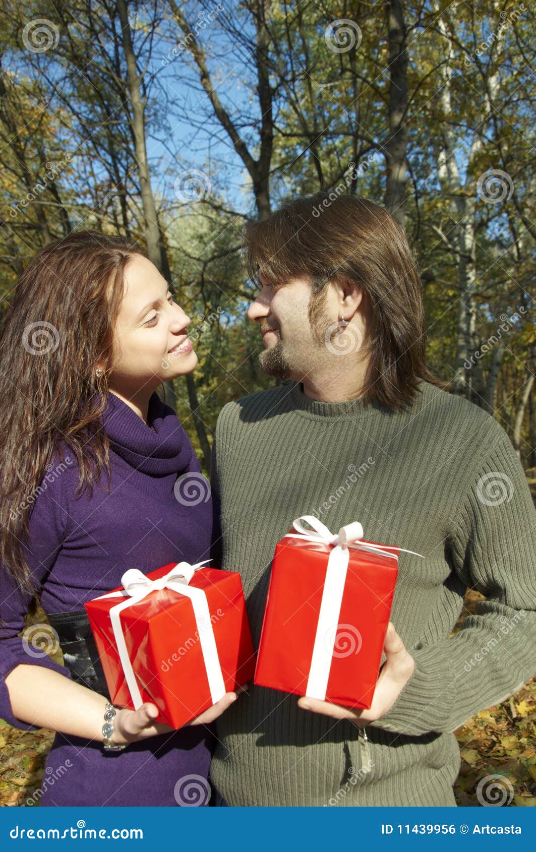 Young couple gives gifts stock photo. Image of family - 11439956