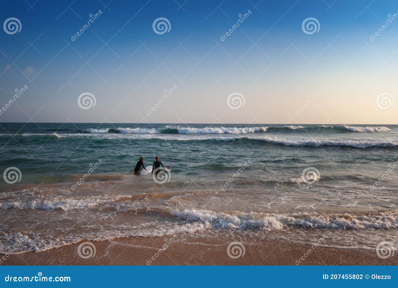 Young Couple Going into Ocean Waves with Surfboards on Beautiful ...