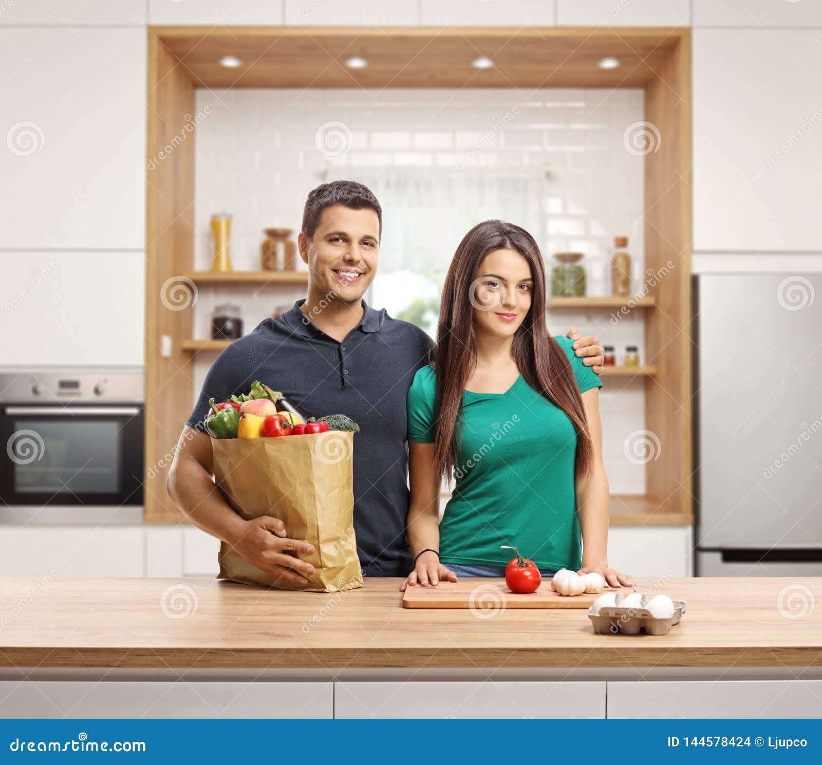 Young Couple with Groceries Cooking in a Kitchen Stock Photo - Image of ...