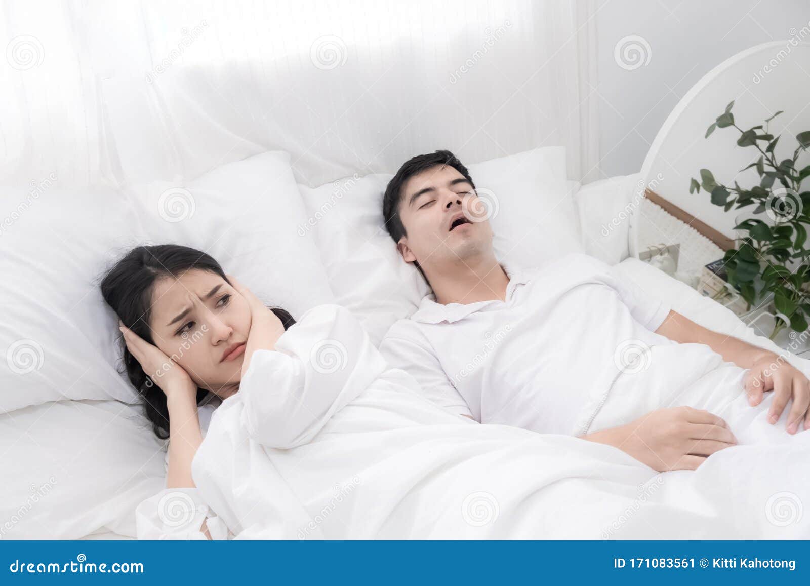 Young Couple Have Problem with Man`s Snoring. Heterosexual Couple in ... Young Couple Have Problem with Man`s Snoring. Heterosexual Couple in ...