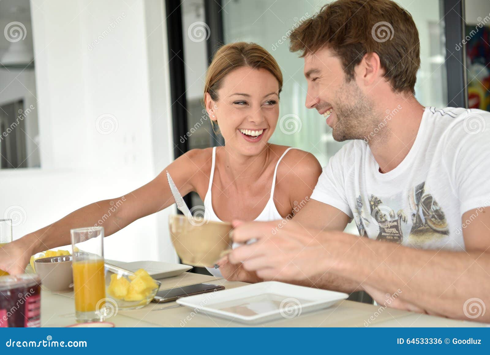 Young Couple Having Breakfast Feeling Happy Stock Photo - Image of ...
