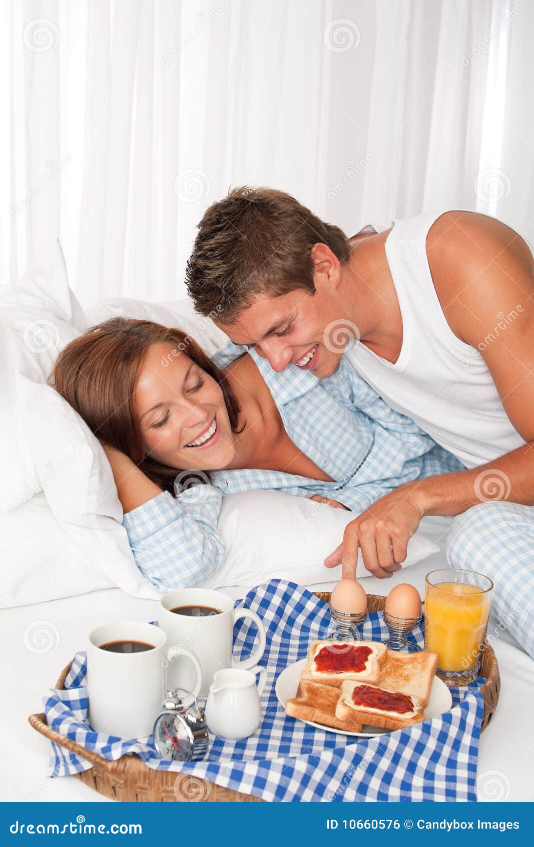 Young Couple Having Breakfast Together Stock Photo - Image of pajamas ...