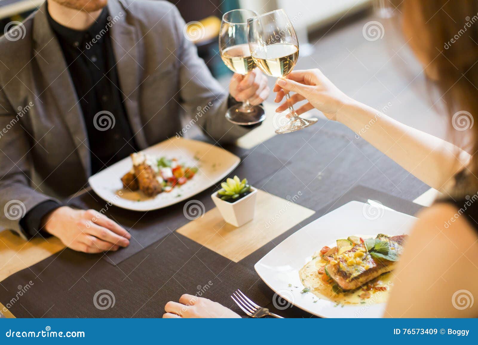 Young couple having diner stock image. Image of sitting - 76573409