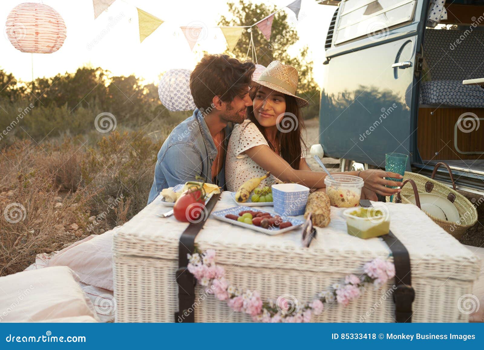Young Couple Having a Picnic beside a Camper Van Embracing Stock Photo ...