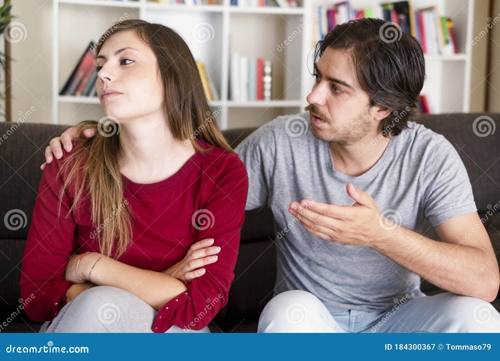 Young Couple Is Having A Quarrel While Sitting On Sofa At Home Stock