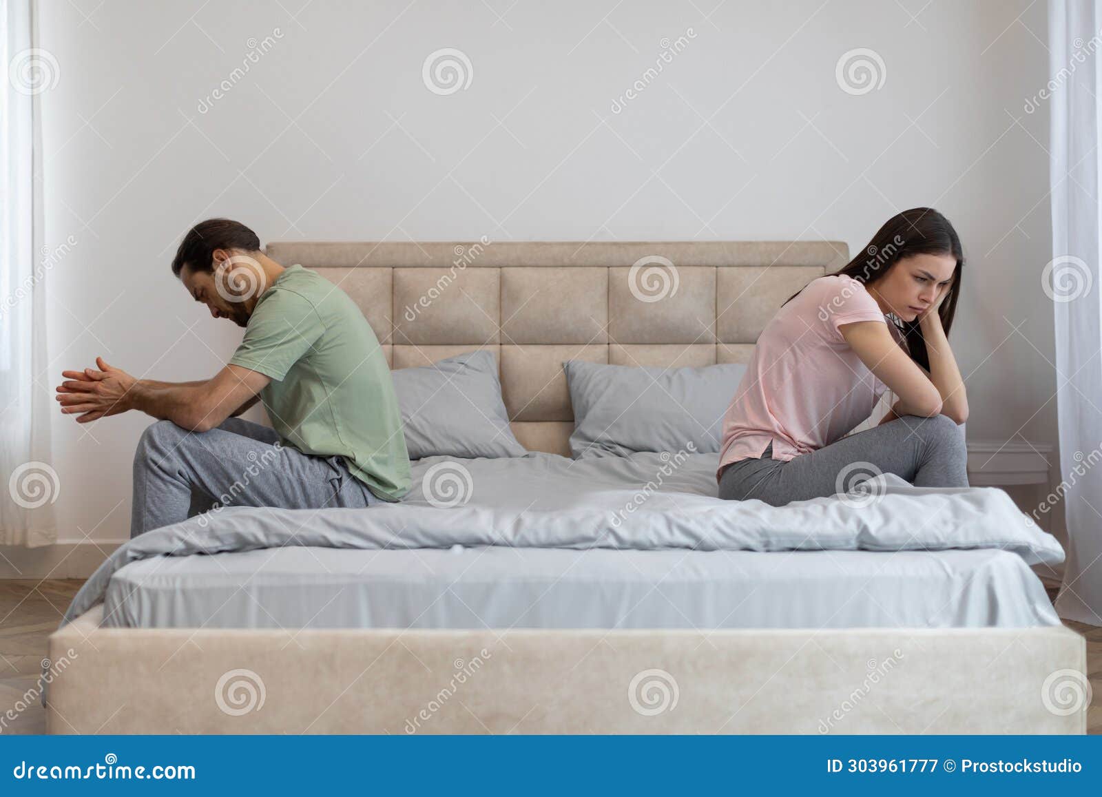 Young Couple Having Relationship Difficulties Sitting On Opposite