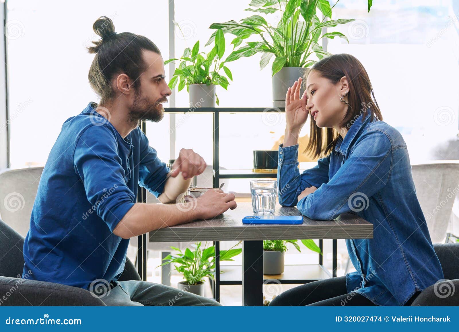 Young Couple Having Serious Conversation while Sitting Together in Cafe ...