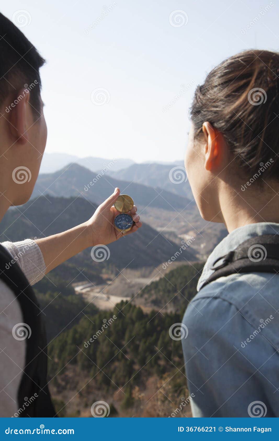Young Couple Hiking and Looking at the Compass Stock Image - Image of ...
