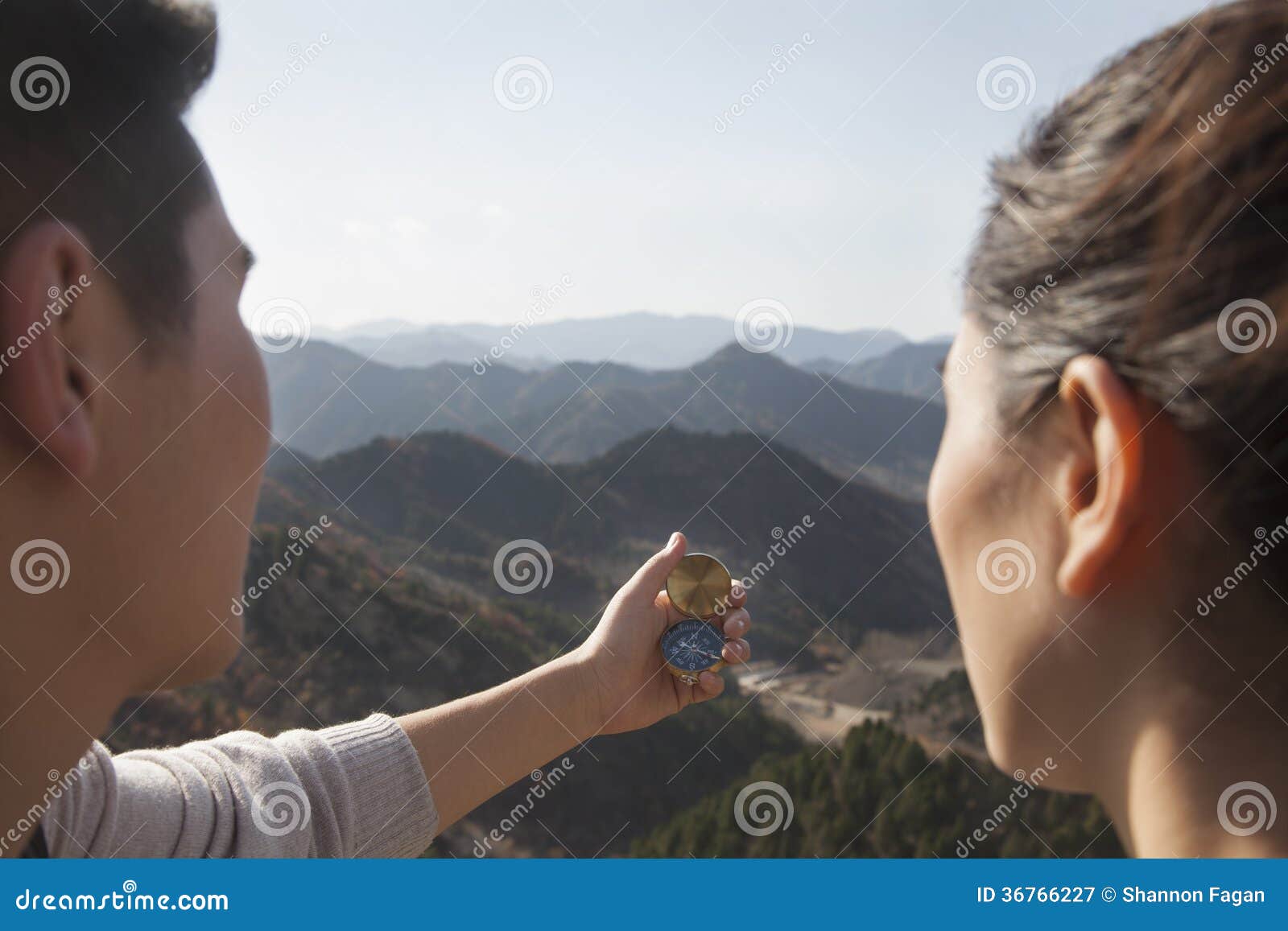 Young Couple Hiking and Looking at the Compass Stock Image - Image of ...