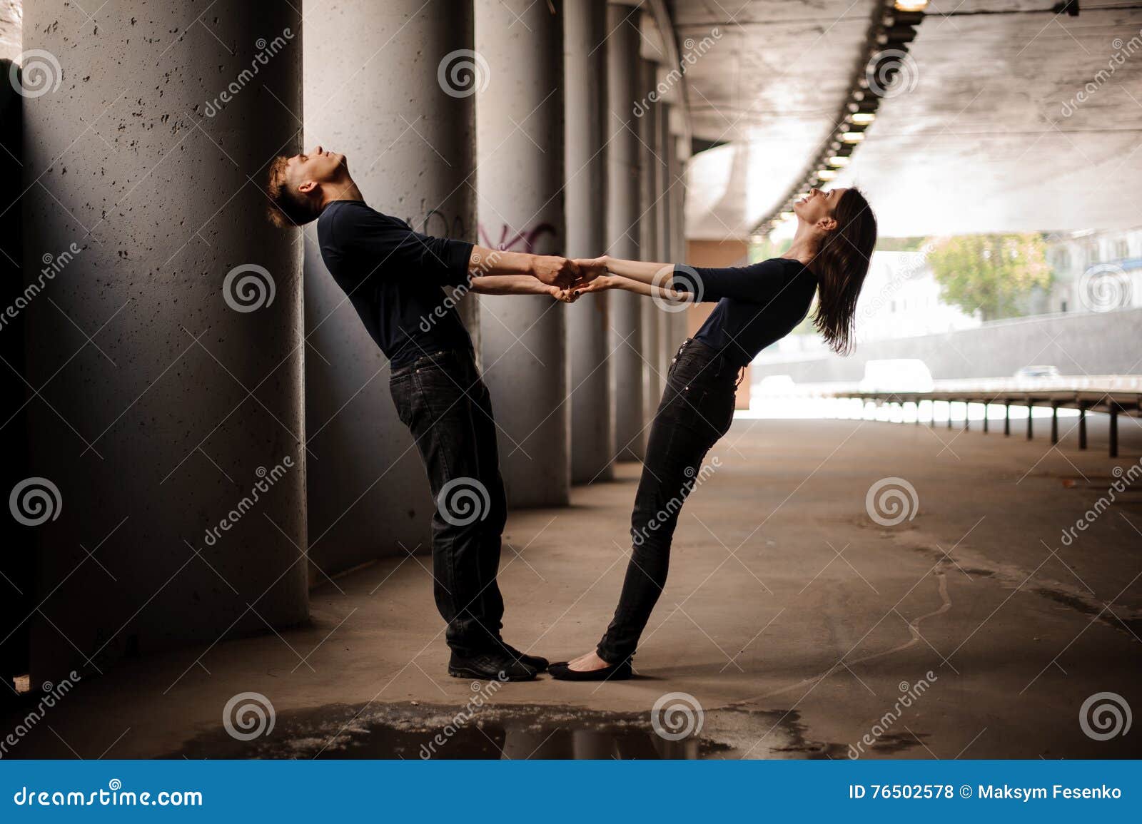 Young Couple Holding Hands and Leaning Back, Trusting Each Other Stock ...