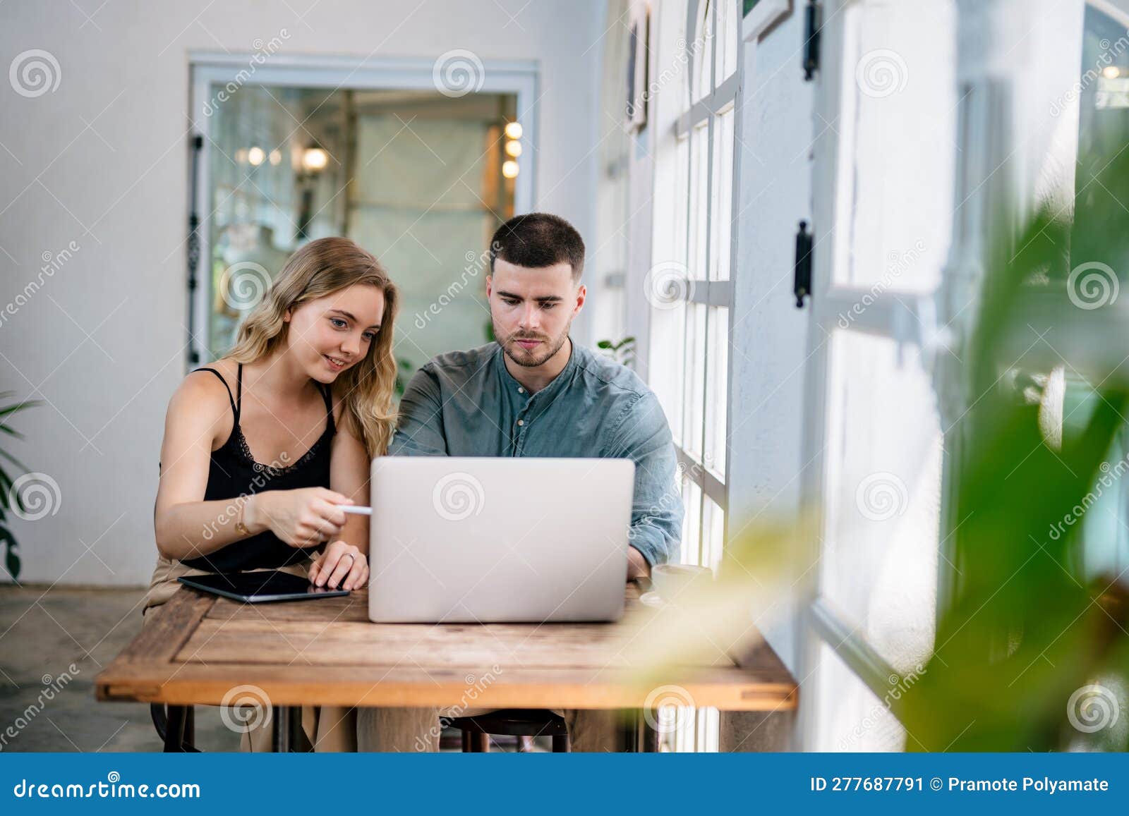 Young Couple at Home in Lounge Using Laptop Computer. the Concept of ...