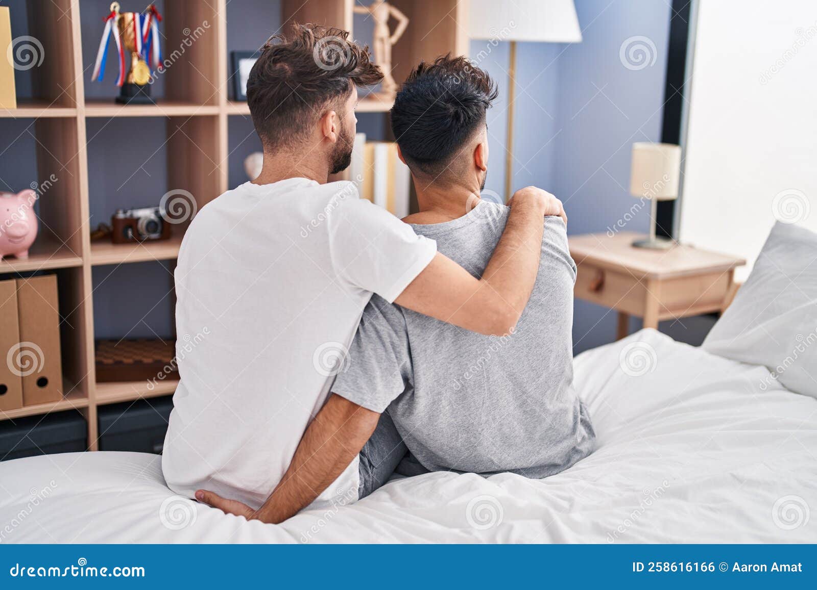 Young Couple Hugging Each Other Sitting on Bed at Bedrooom Stock Photo ...