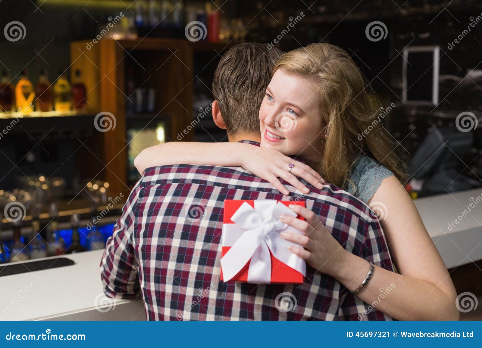 Young Couple Hugging with a Gift Stock Image - Image of attractiv ...