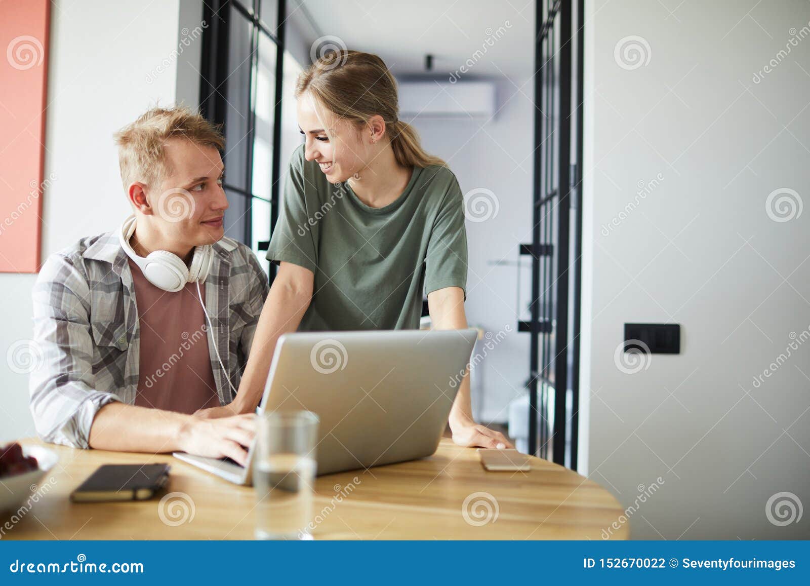 Young Couple Interacting by Table Stock Photo - Image of boyfriend ...