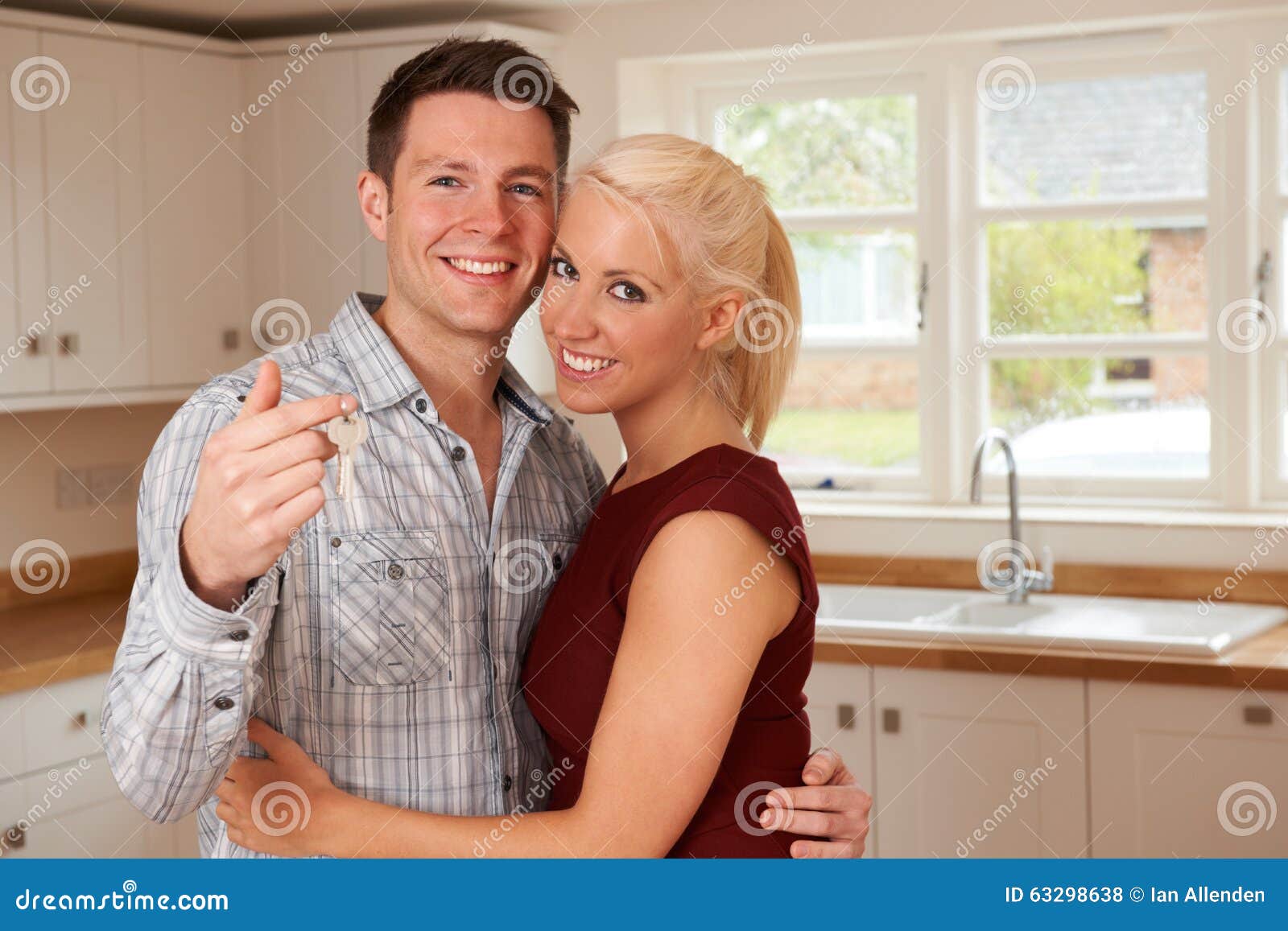 Young Couple with Keys To New Home Stock Photo - Image of real, indoors ...